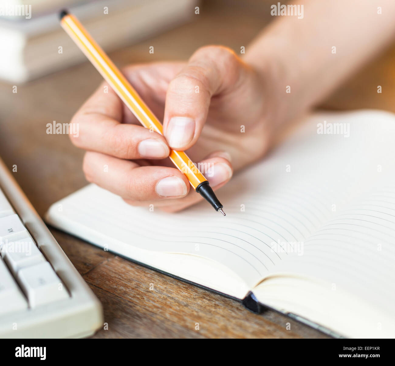Female hand writes in a notebook diary Stock Photo - Alamy
