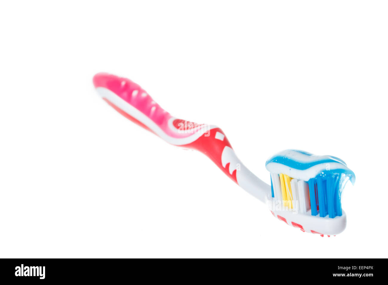 Red toothbrush with blue two color toothpaste on light surface. Photo ...