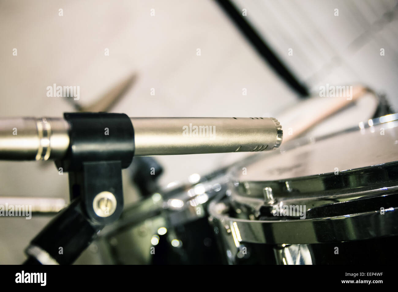 vintage retro professional microphone placed close to drums with sticks ...