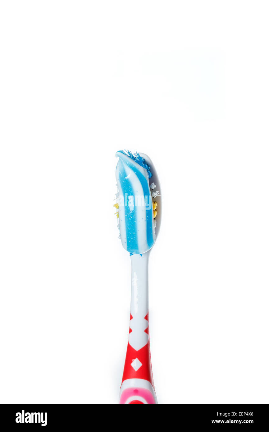 Red toothbrush with blue two color toothpaste on light surface. Photo ...