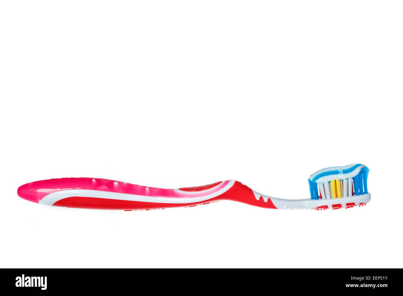 Red toothbrush with blue two color toothpaste on light surface. Photo ...