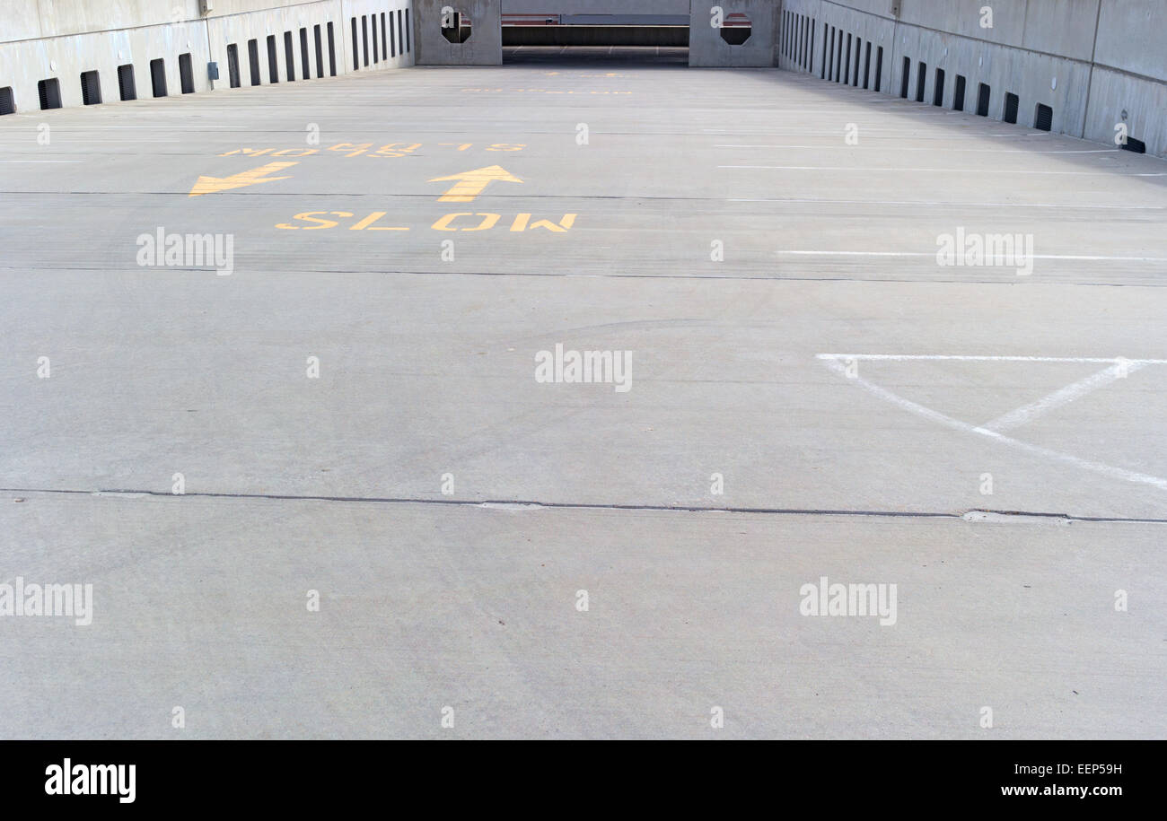 A wide parking area with ramp leading down to an exit Stock Photo - Alamy