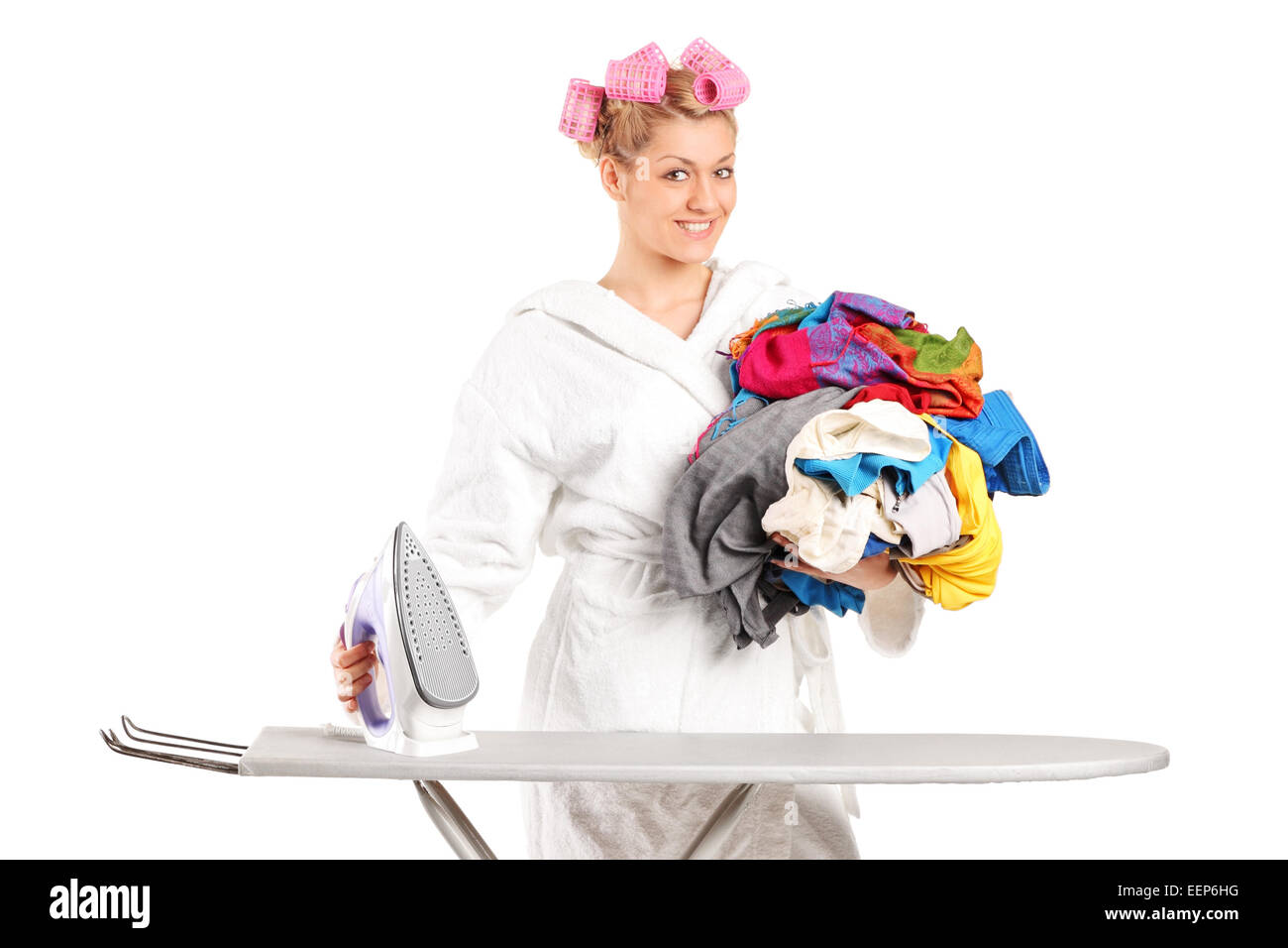 Woman in bathrobe preparing clothes for ironing isolated against white ...
