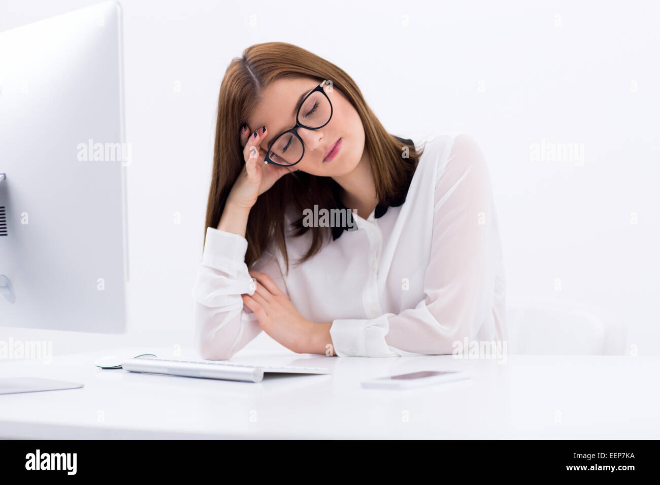 Tired beautiful business woman sitting at her workplace with closed ...