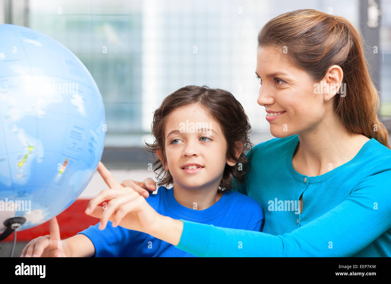 Happy school concept. Female teacher explaining geography to kid Stock ...