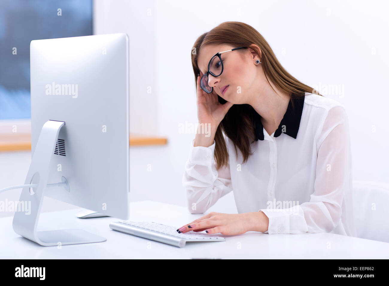 Tired businesswoman working in office Stock Photo - Alamy