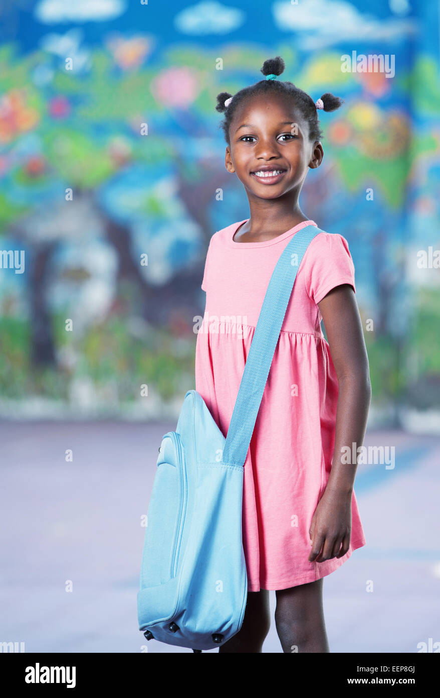 Happy afroamerican female student in elementary schoolyard Stock Photo ...