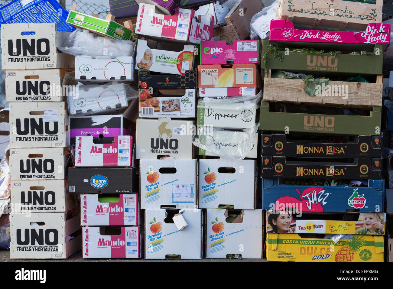 Empty fruit boxes piled up at an outdoor market Stock Photo - Alamy