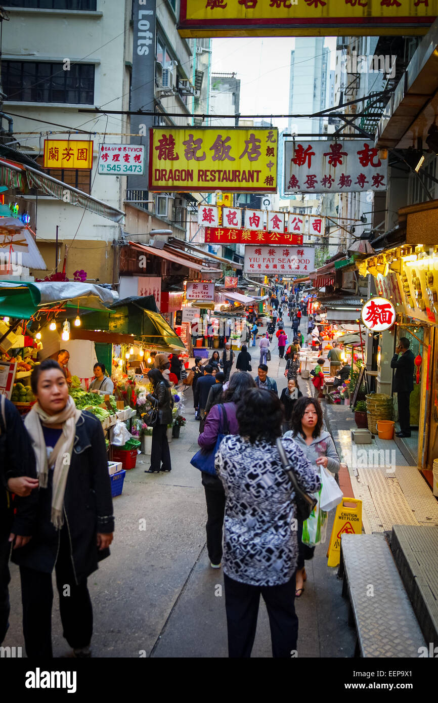 People walking past shops and market stalls on Gage Street, Hong Kong ...
