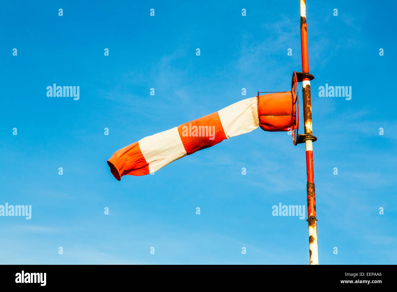 Windsock, on a rusty pole, for the determination of wind direction and ...