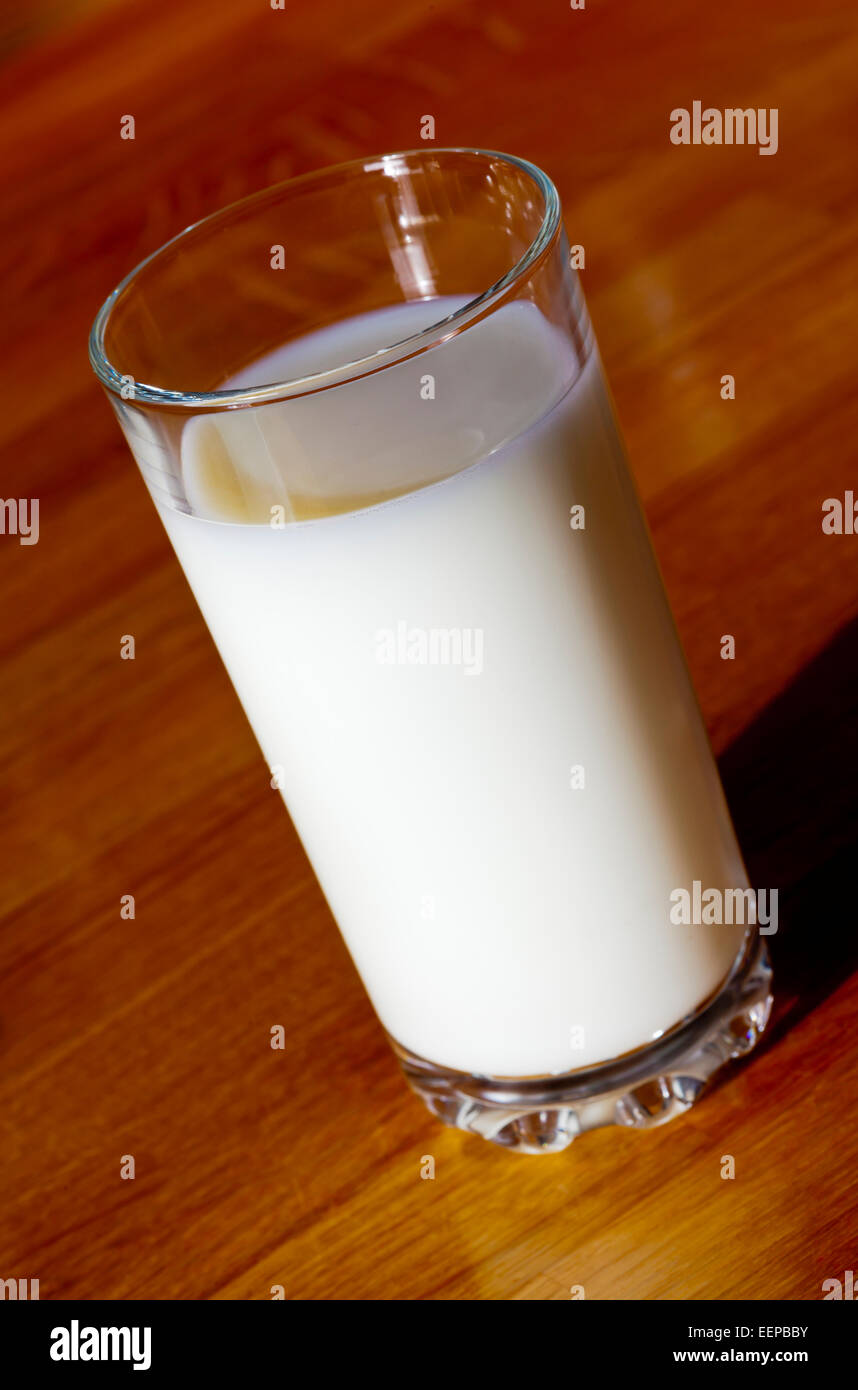 A glass of milk on a wooden surface Stock Photo - Alamy