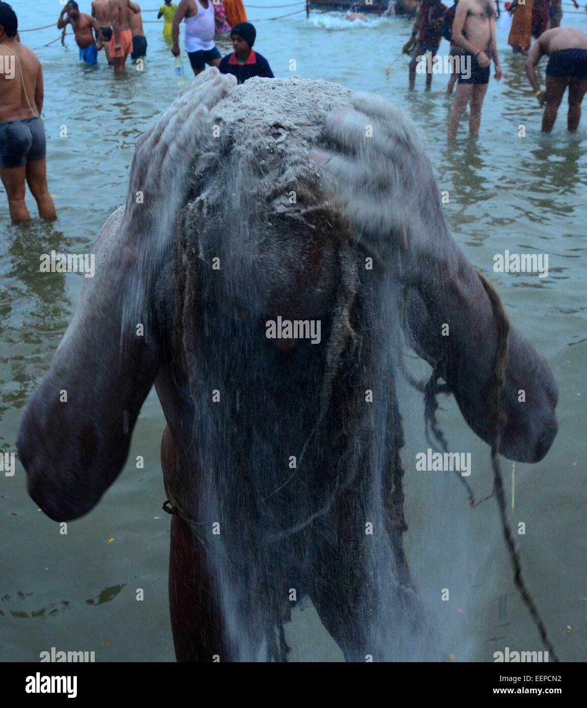 A Naga Sadhu applying ashes over his body after taking holydip at ...