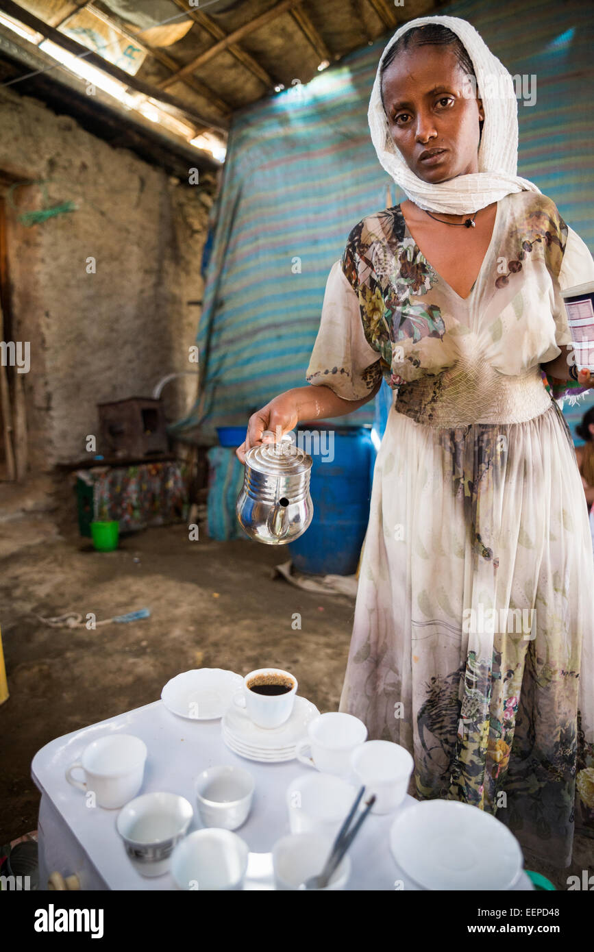Ethiopian woman preparing freshly brewed coffee, Berhale, Ethiopia ...