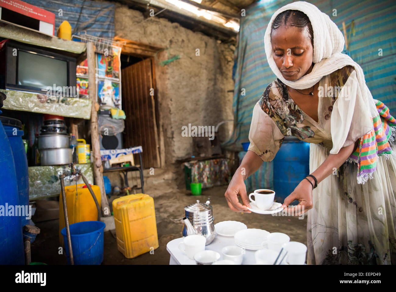 Ethiopian woman preparing freshly brewed coffee, Berhale, Ethiopia ...