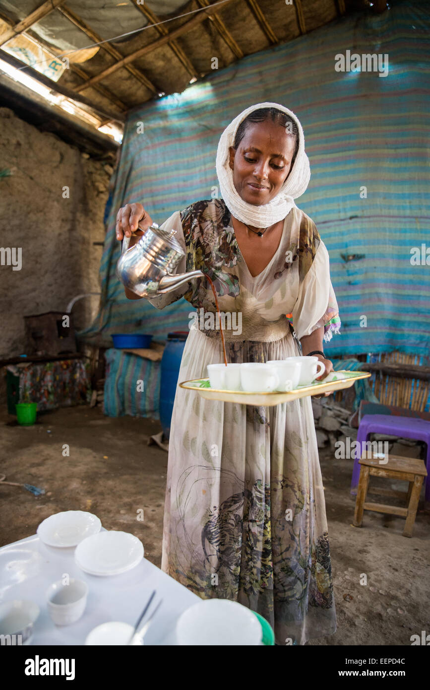 Ethiopian woman preparing freshly brewed coffee, Berhale, Ethiopia ...