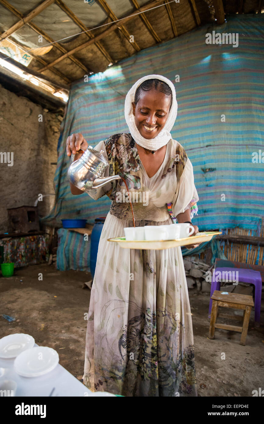 Ethiopian woman preparing freshly brewed coffee, Berhale, Ethiopia ...