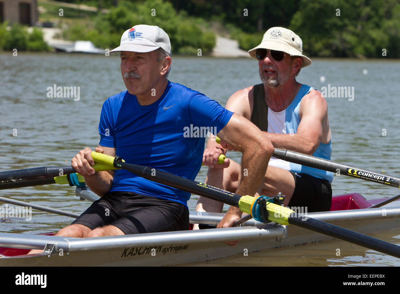 Two seniors rowing Stock Photo - Alamy