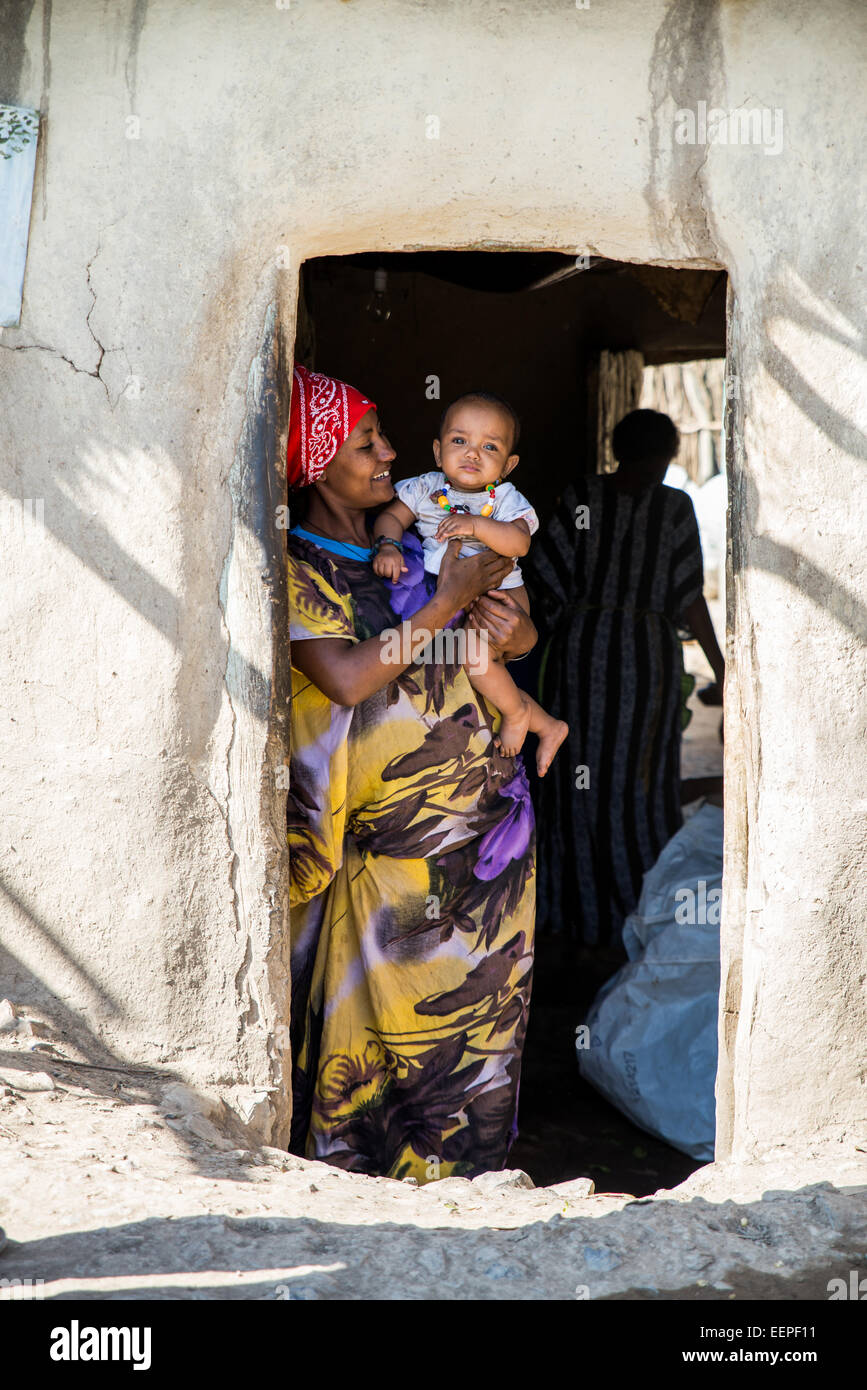 Woman and her child stand in the doorway of home, Ethiopia, Africa ...