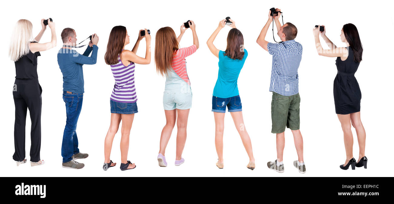 Back view group of people photographed attractions. Rear view team ...