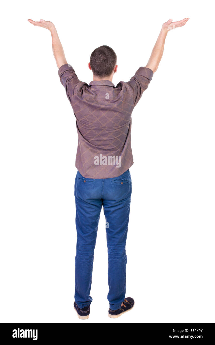 Back view of Beautiful man in jeans looking at wall and Holds hand up ...
