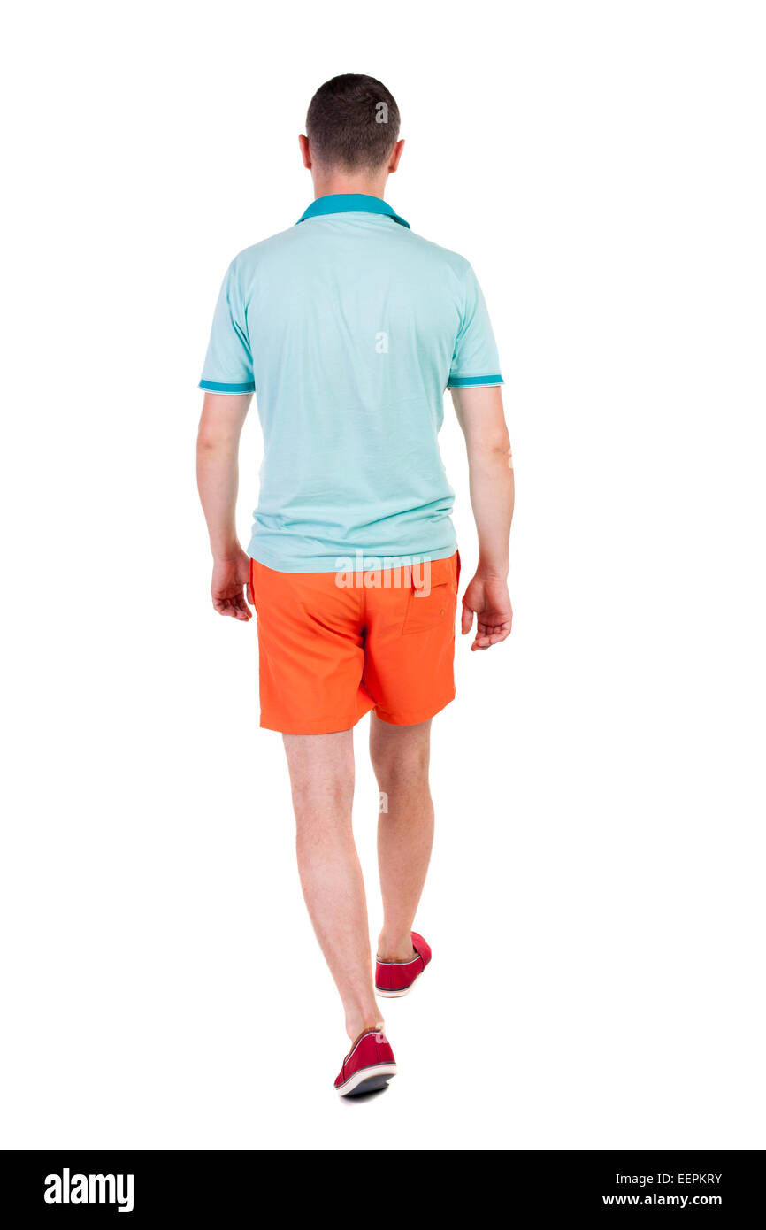 Back view of going handsome man in shorts. walking young guy . Rear ...