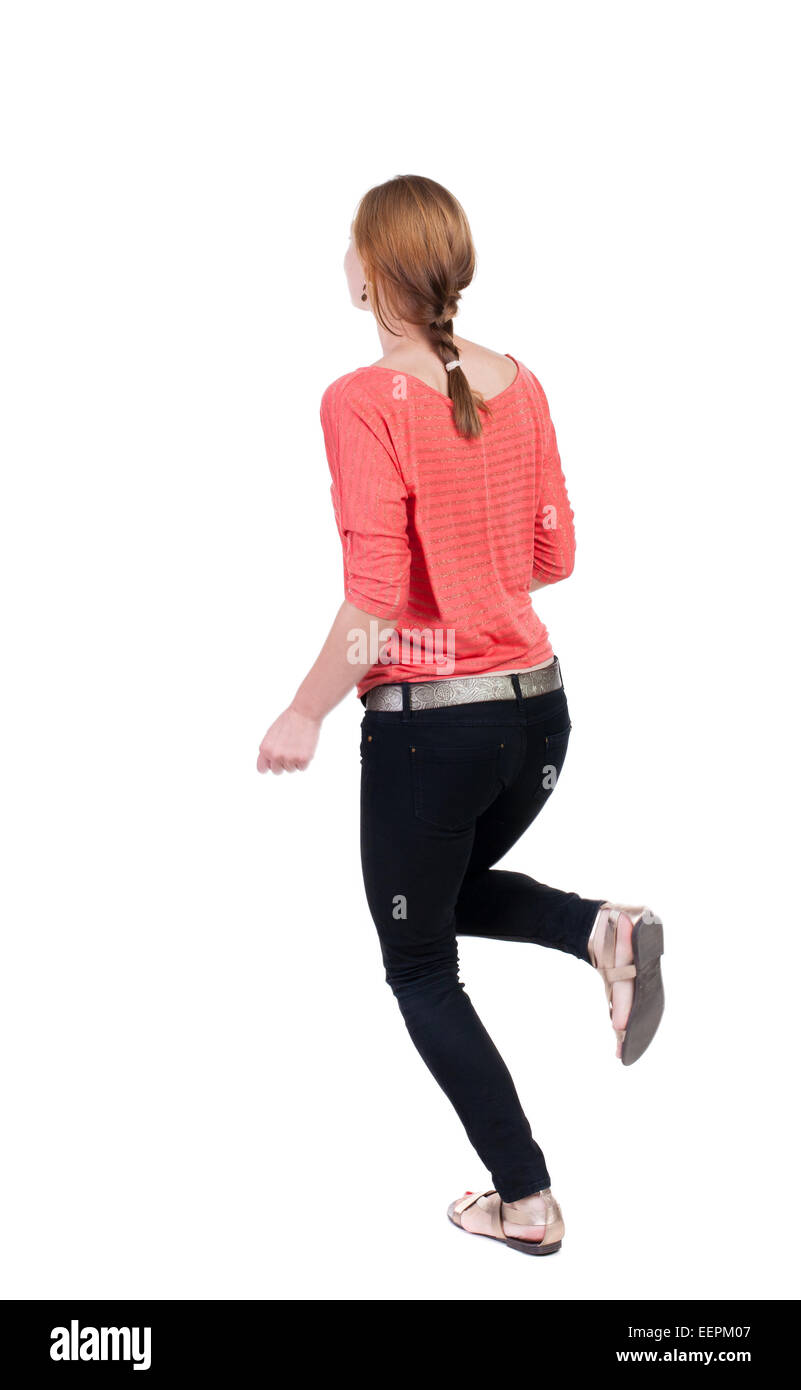 back view of running woman in jeans. beautiful blonde girl in motion ...