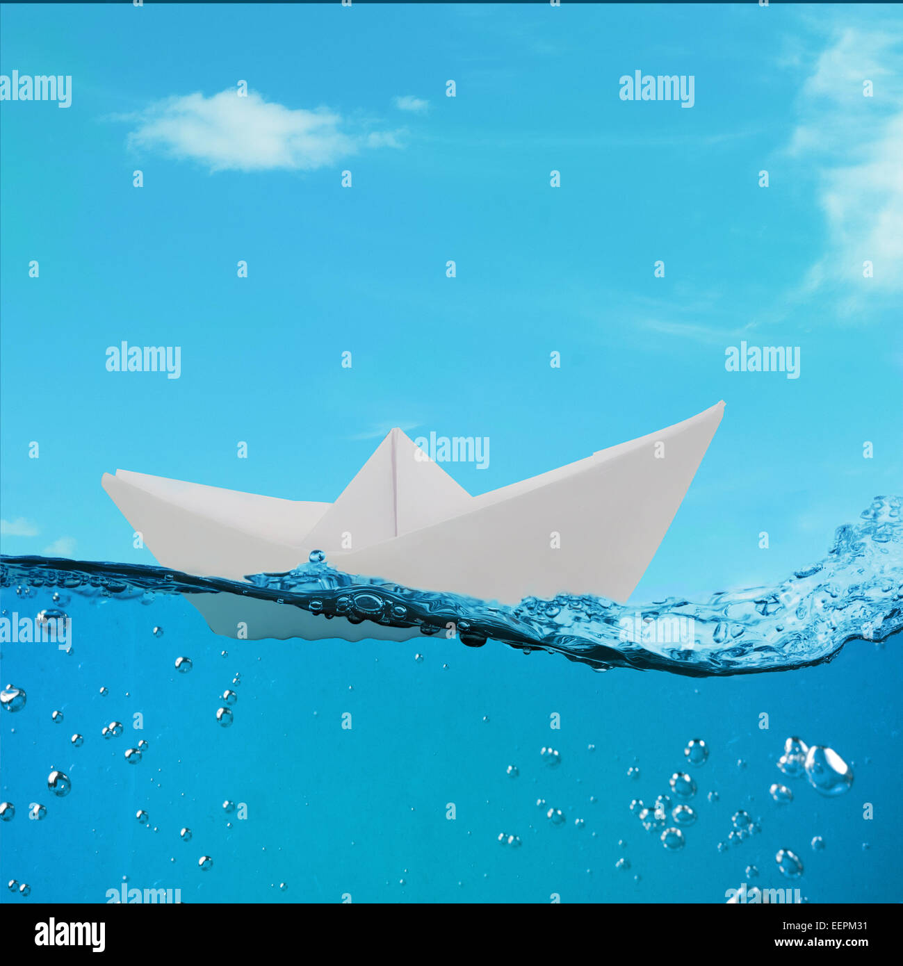 paper boat floating among the waves in the ocean. origami boat floating ...