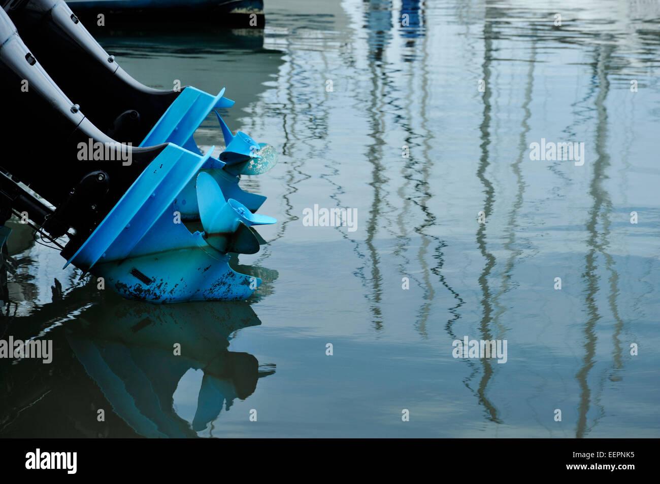 Still life of 2 motor boat engine propellers reflecting on water in ...