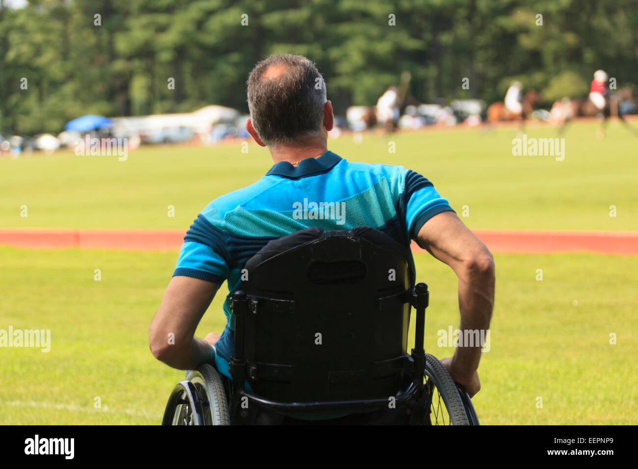 Man with spinal cord injury watching polo Stock Photo - Alamy