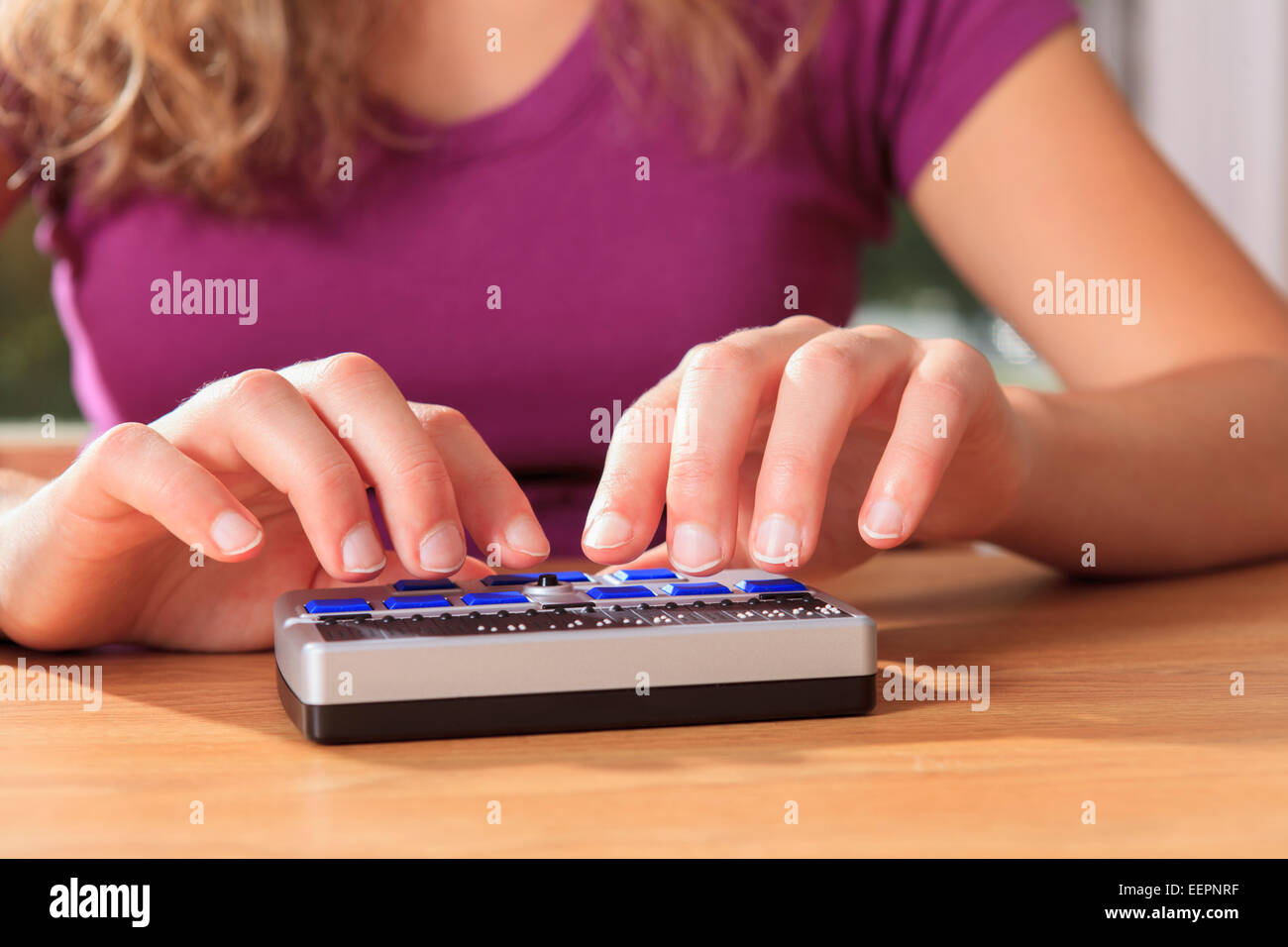 Student with visual impairment using her Braille display to communicate ...