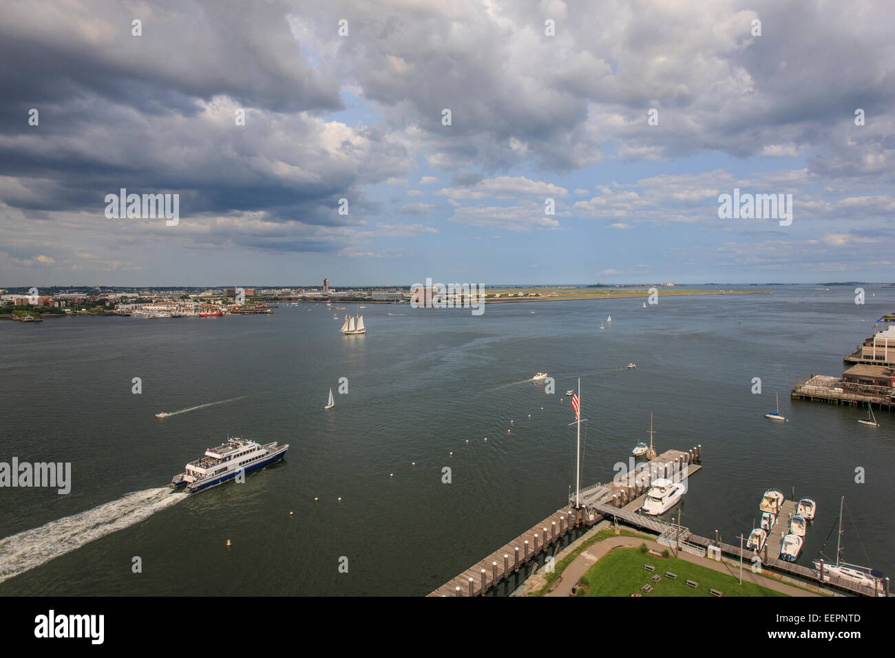 Commuter boats at Boston Harbor with Logan Airport and Fan Pier, Boston ...