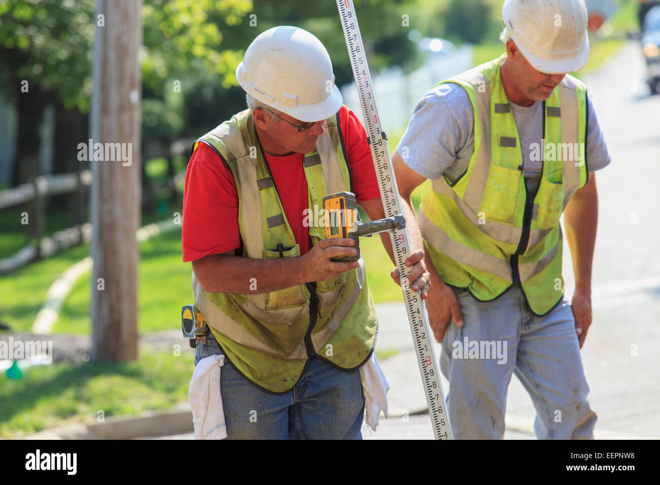 Construction supervisor using electronic surveying rod Stock Photo - Alamy