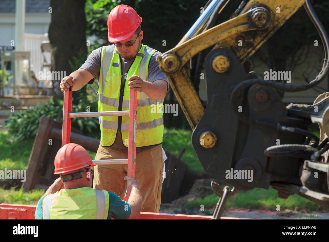 Construction workers climbing down ladder into shoring Stock Photo - Alamy