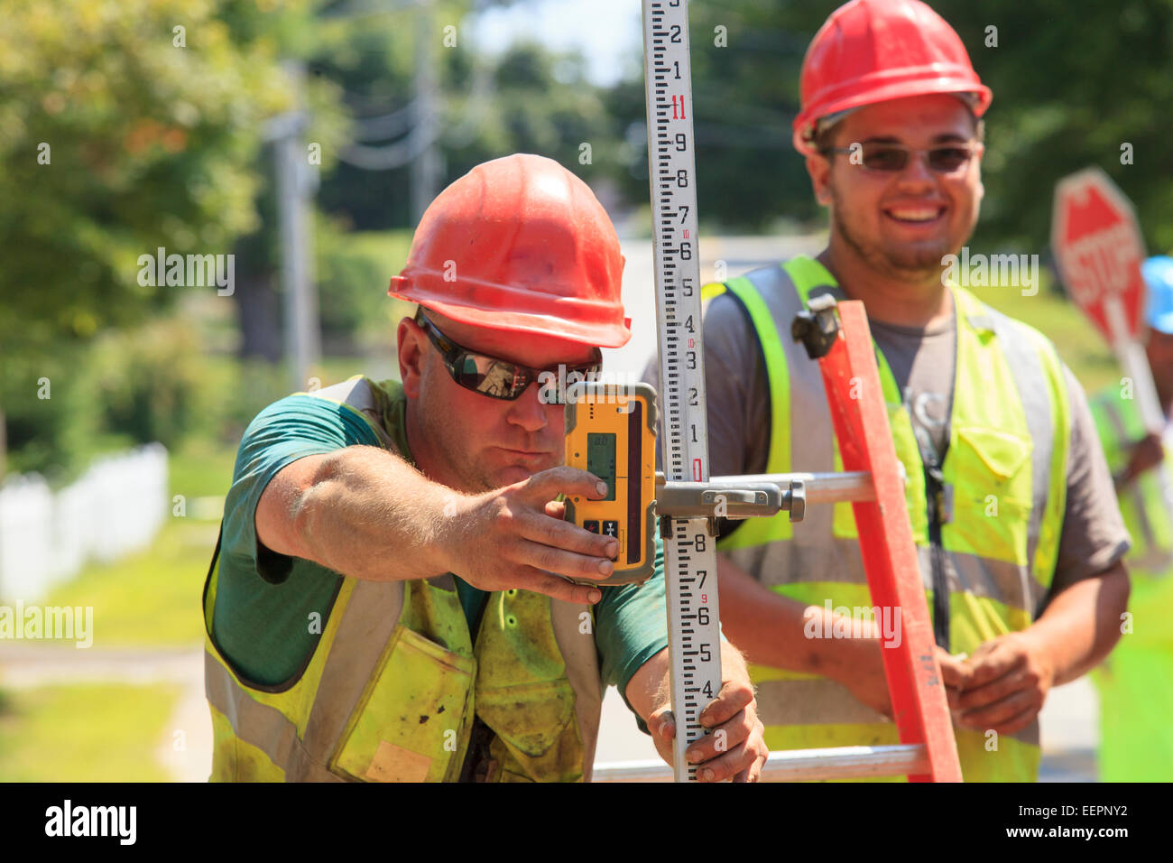 Construction supervisor using electronic surveying rod Stock Photo - Alamy