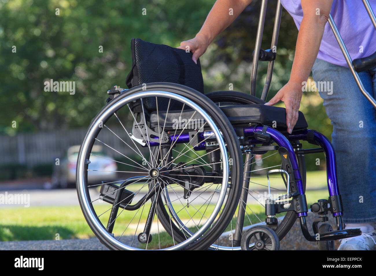 Woman with Spina Bifida using crutches to put wheelchair together after ...