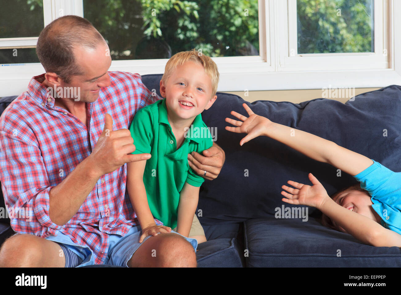 Father and sons with hearing impairments signing 'play' in American ...