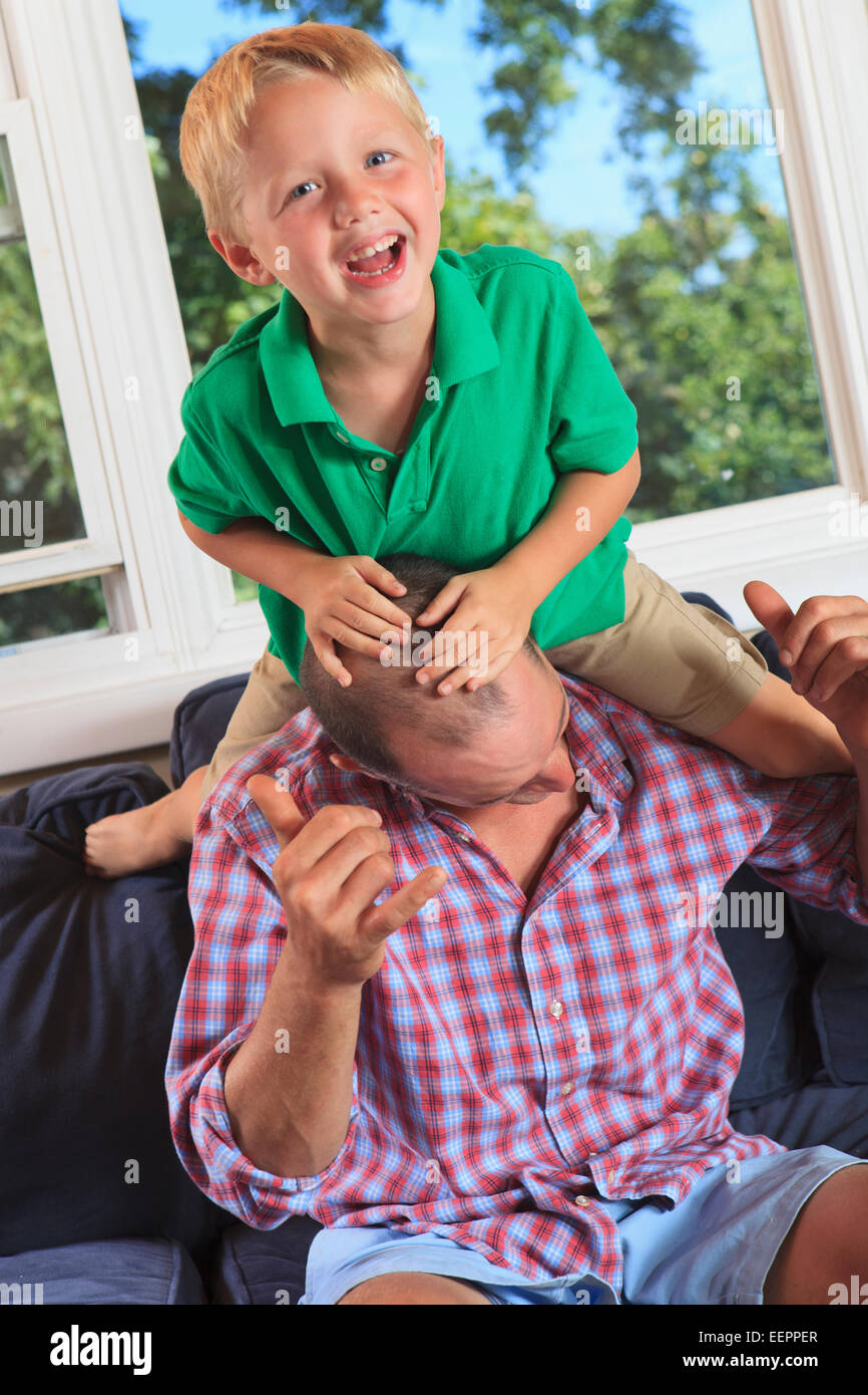 Father and son with hearing impairments signing 'play' in American sign ...