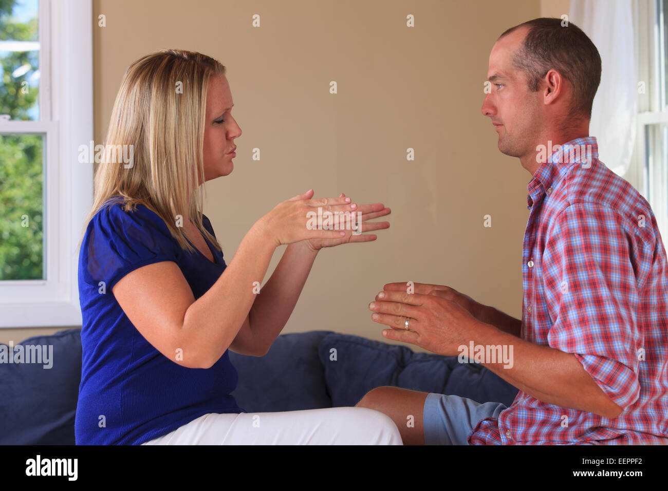 Husband and wife with hearing impairments signing in American sign ...