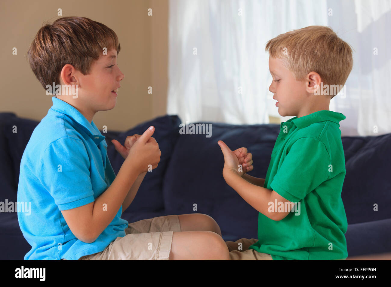 Boys with hearing impairments signing 'sports' in American sign ...