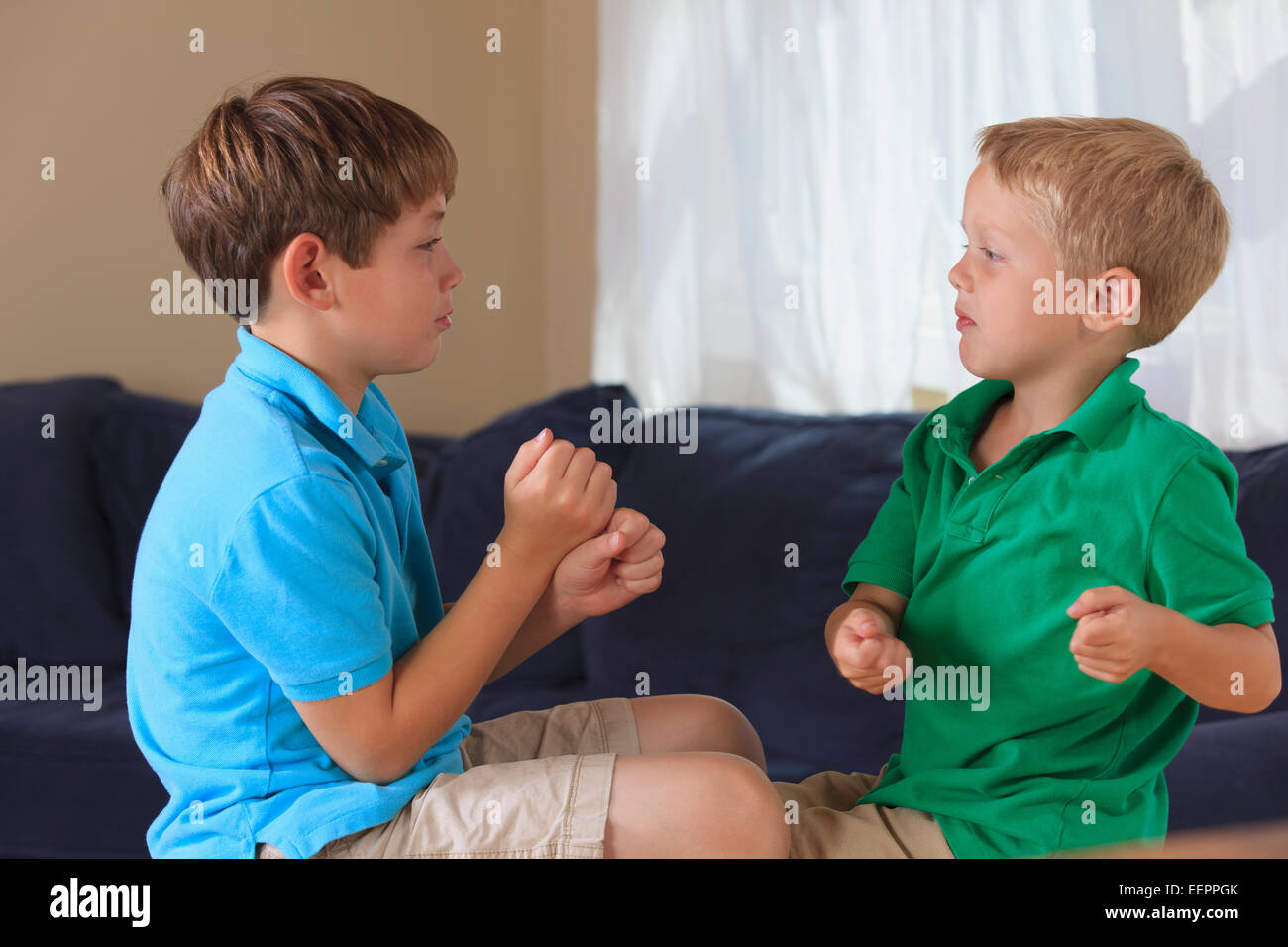 Boys with hearing impairments signing 'win' in American sign language ...