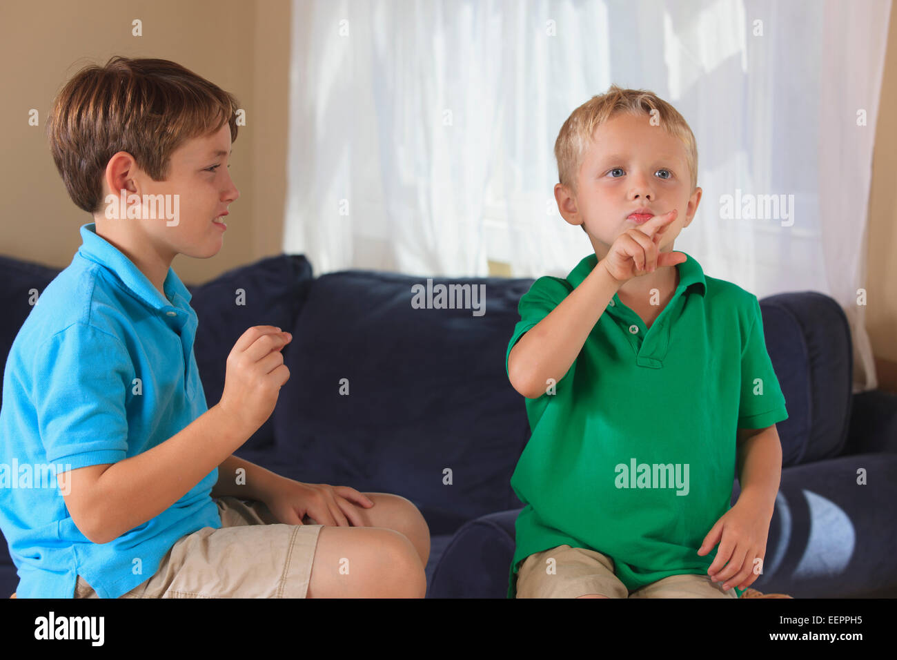 Boys with hearing impairments signing 'duck' in American sign language ...