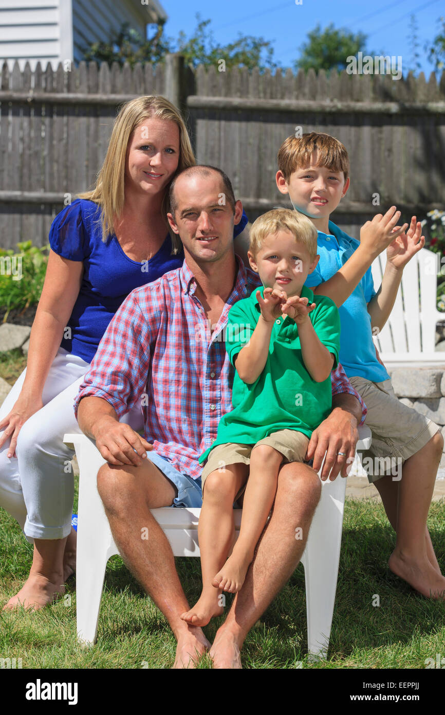 Portrait of a happy family with hearing impairments signing in American ...