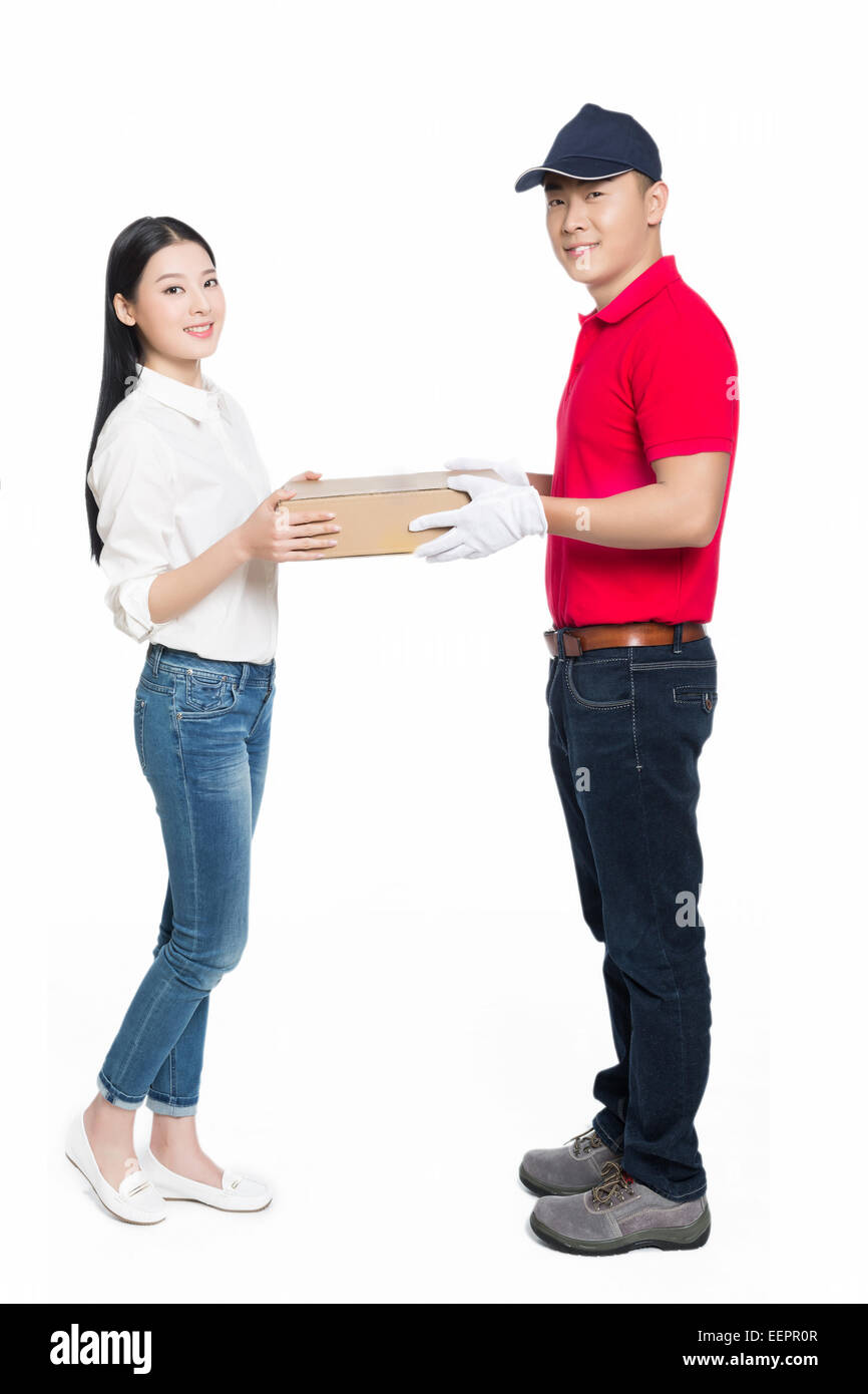 young courier deliver package to pretty woman, white background Stock ...