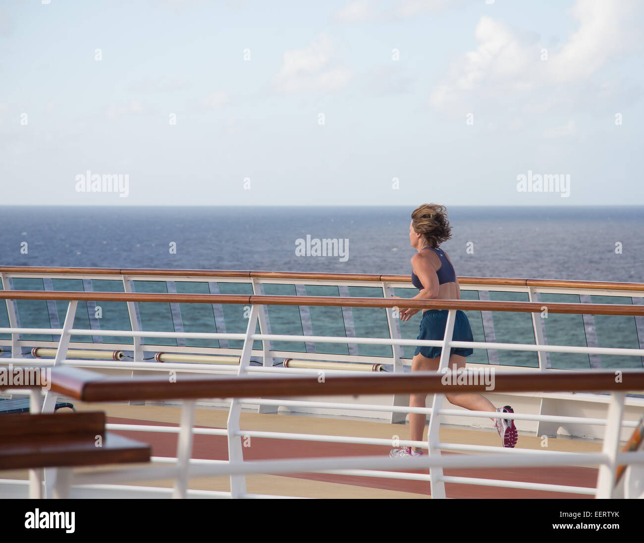 A woman running on the track of a luxury cruise ship Stock Photo - Alamy