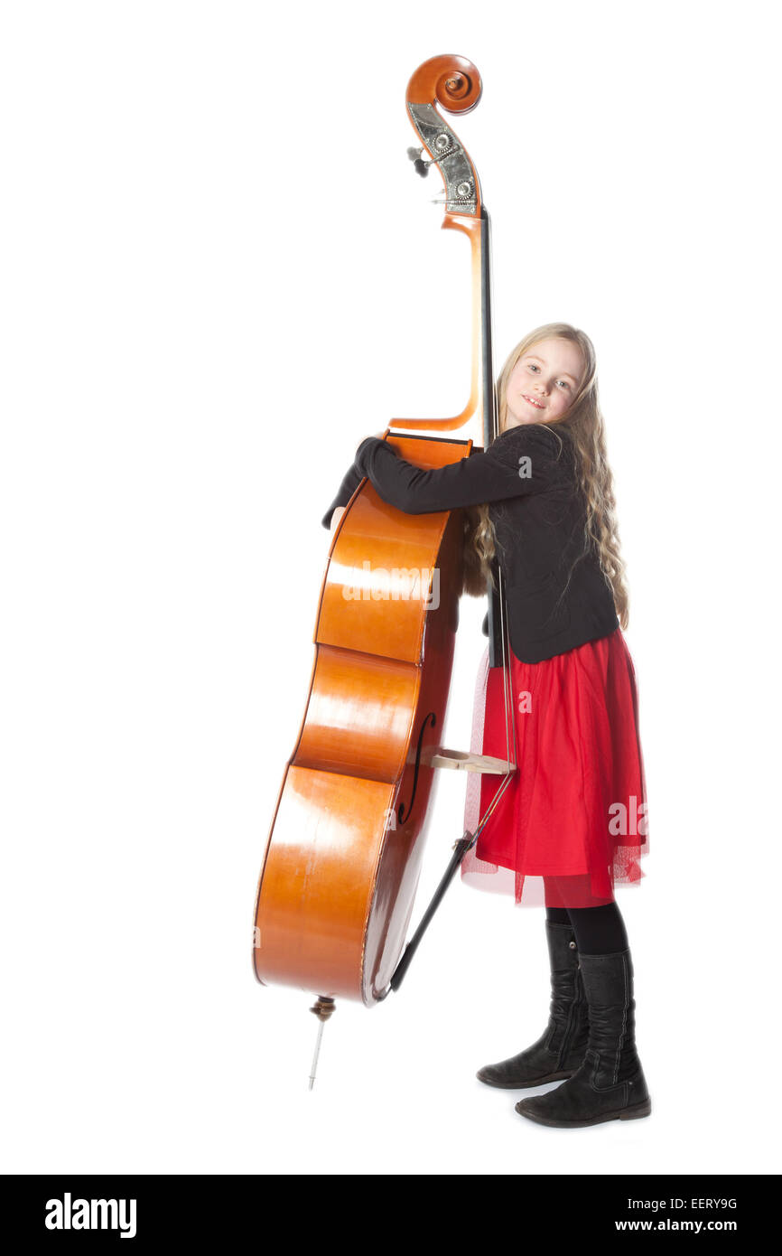 young blond girl embraces double bass in studio against white ...