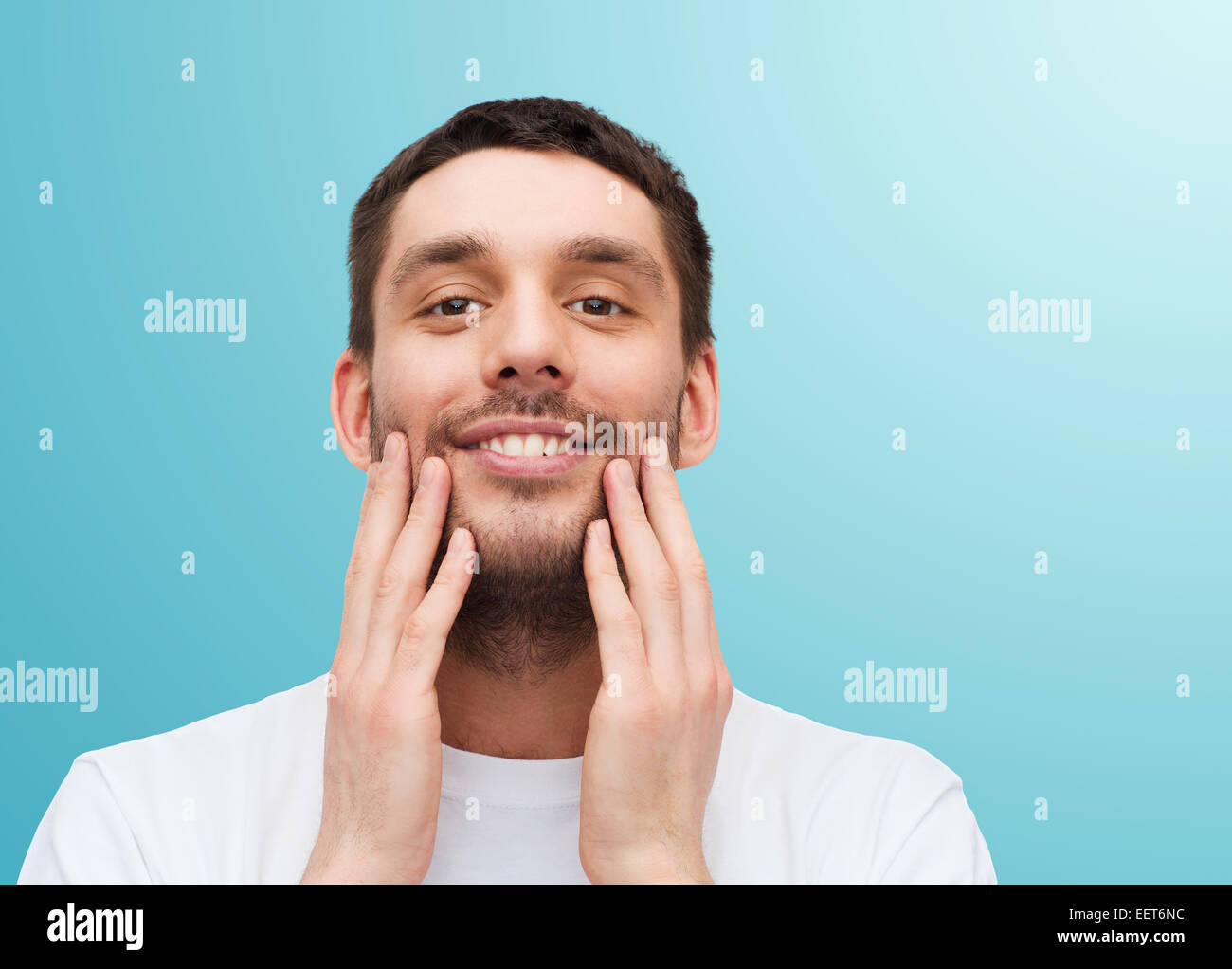 beautiful smiling man touching his face Stock Photo - Alamy