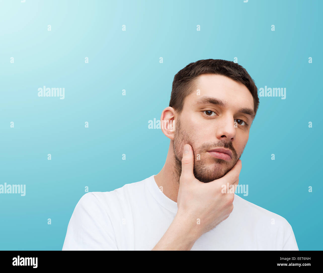 beautiful calm man touching his face Stock Photo - Alamy