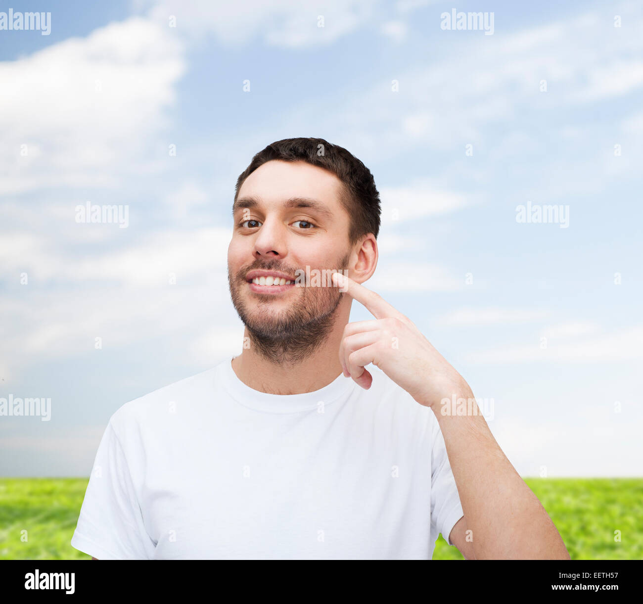 Pointing at cheek hi-res stock photography and images - Alamy