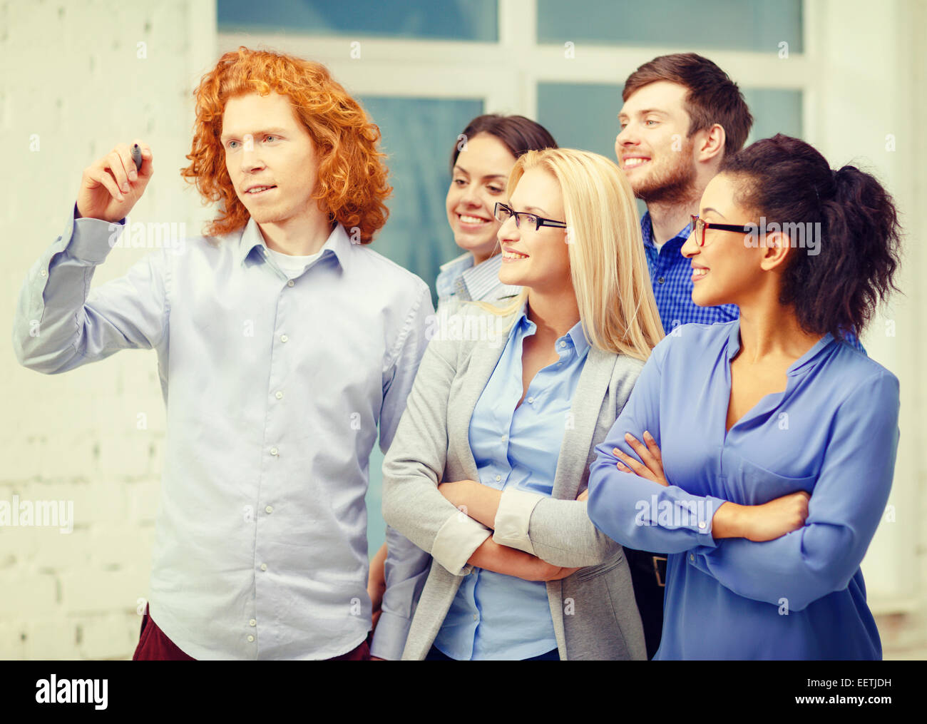 smiling creative team writing on virtual screen Stock Photo - Alamy
