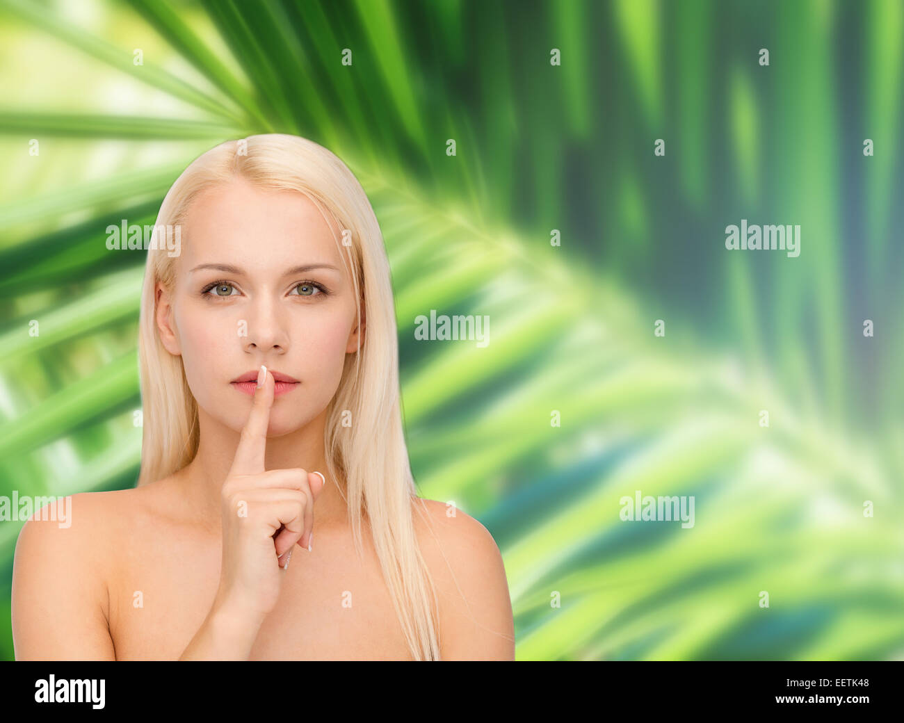calm young woman with finger on lips Stock Photo - Alamy